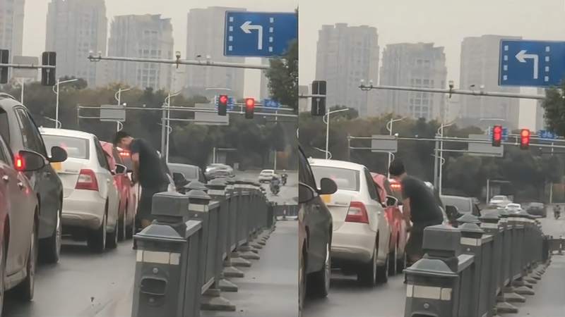 男子当街用打气筒给汽车胎打气,边打气边看红绿灯:能打1秒是1秒