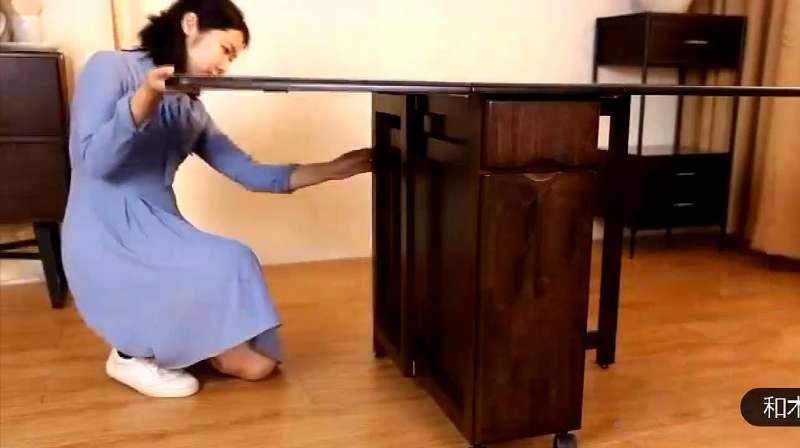 美女演示可以折叠的实木餐桌