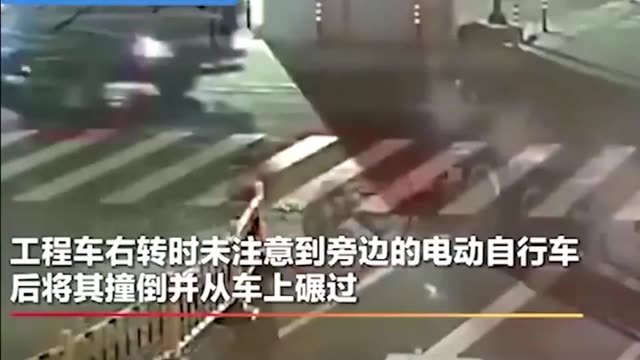 电动车与大货车相撞被碾粉碎,骑车人一个翻滚死里逃生,监控拍下惊魂一刻