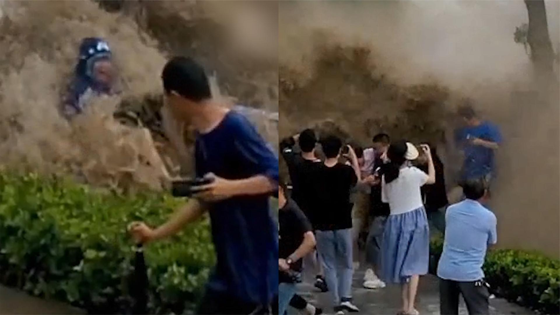 注意安全!市民围观钱塘江大潮被浪花拍倒 抱着大树防冲走