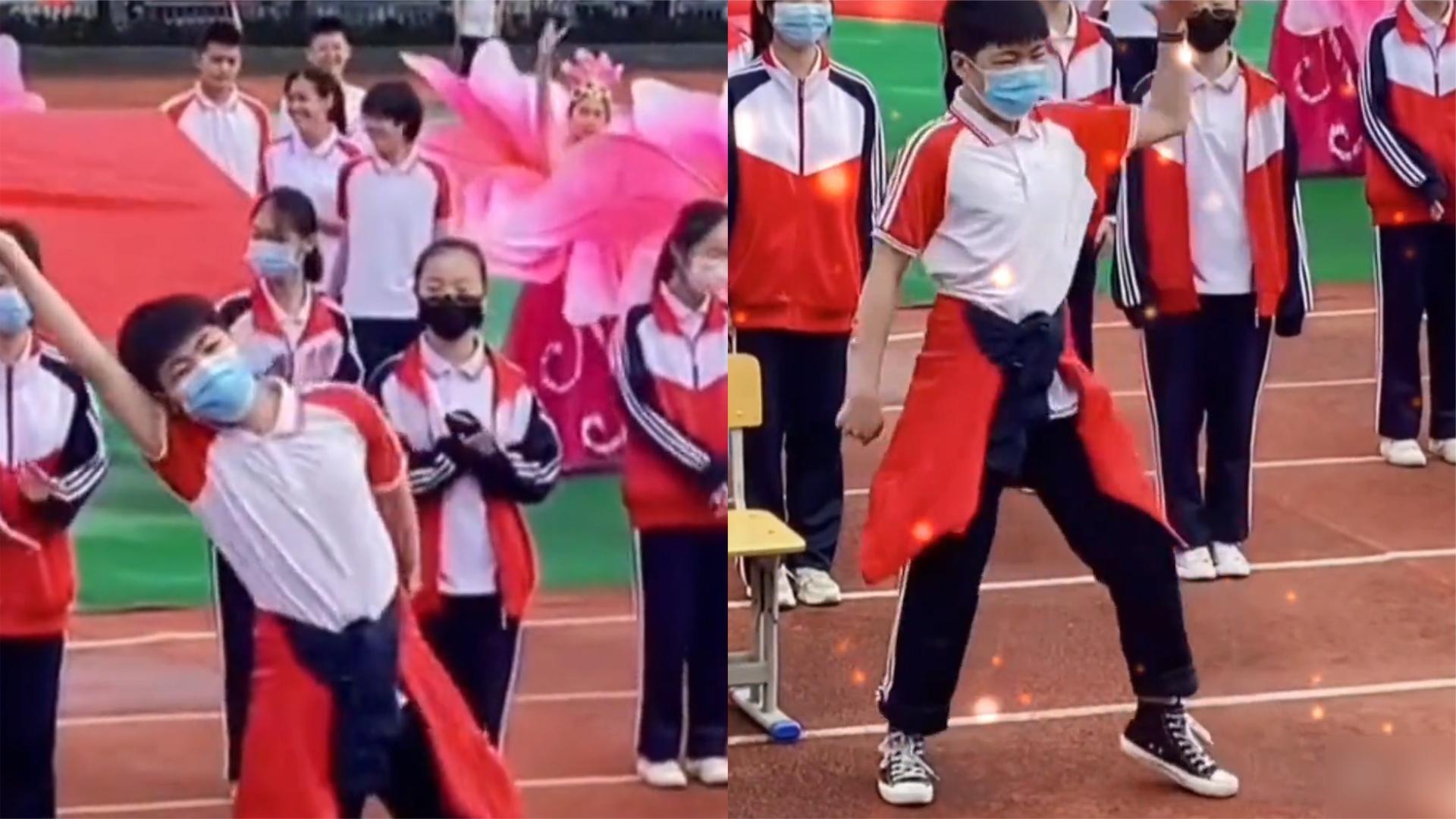 运动会上男生独舞表演,舞姿妖娆跟随音乐翩翩起舞,身后花朵亮了