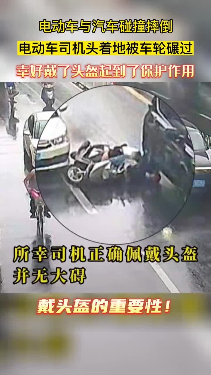 电动车与汽车碰撞摔倒,汽车车轮从电动车司机头上碾过,幸好该司机戴...