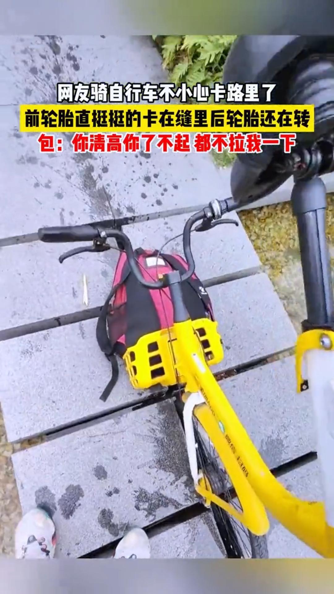 网友骑自行车不慎把前轮卡路里了,车:别拍了,快把我拉出来啊!