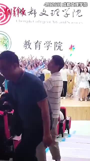 学生展演活动上,在台下观看的指导老师,跟着台上舞动起来鼓励表演的...