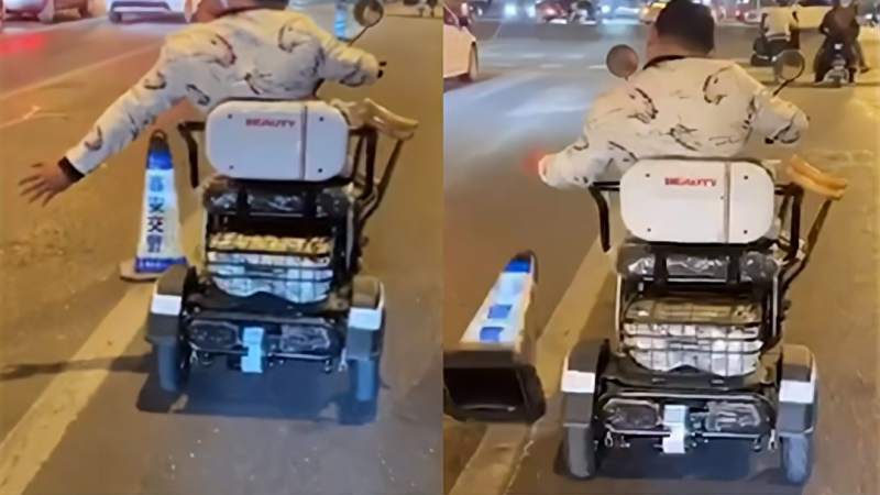 残疾男子坐代步车推倒几十个路障 环卫工无奈跟在后面挨个扶正