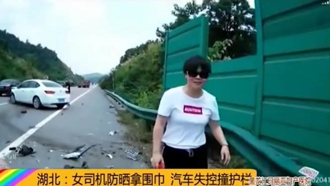 女司机低头拿围巾 轿车突然失控撞护栏 车头损毁严重
