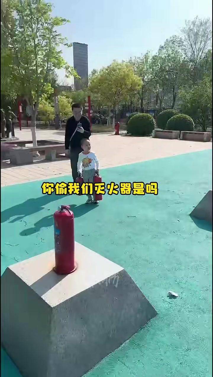 着急接妈妈的小孩哥拎起灭火器放至消防车。Ps:像不像你家娃喜欢...