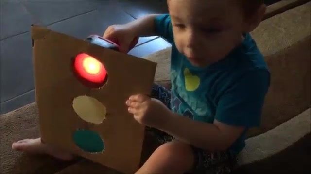 小宝宝自己制作了一个红绿灯,模拟交通好形象