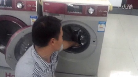 合肥中心---和县沈巷海尔专卖店老板讲解海尔水晶滚筒洗衣机--汤昆摄 ...