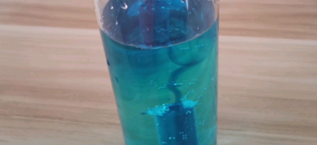 科学小实验:冷热水对流,蓝色热水从细管中逐渐流入外围冷水中