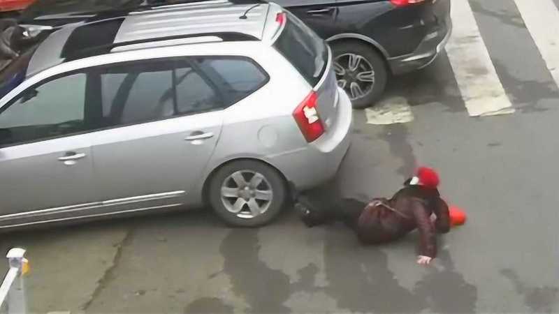 行人正从车尾绕过下一秒不幸被倒车的司机撞骨折