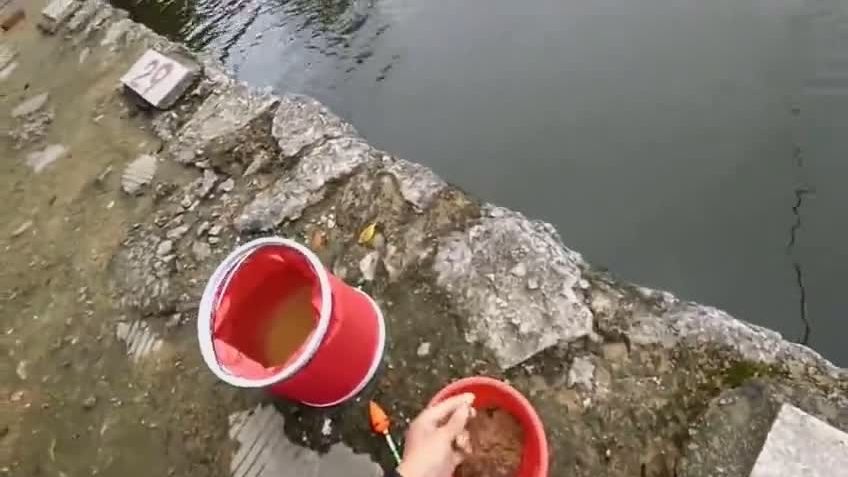 小伙自己发明的自动钓鱼钩在小河里钓鱼