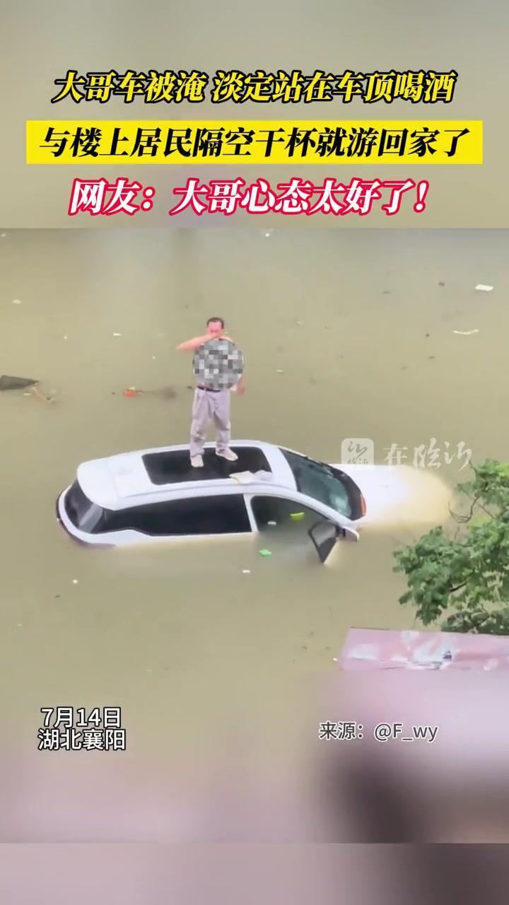 大哥车被淹了,淡定站在车顶喝酒,喝完酒就游回家了。#洪水#别划走#...