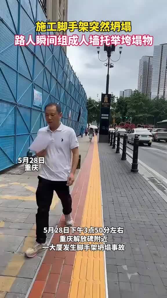 施工脚手架突然坍塌致2人轻伤,路人瞬间组成人墙托举垮塌物