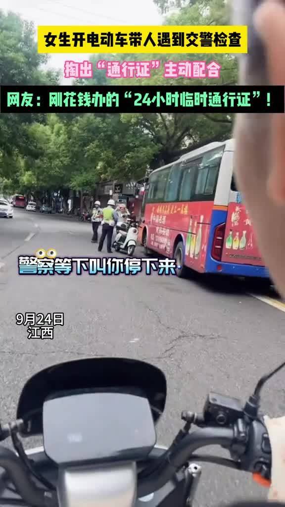 女生开电动车带人遇到交警检查,掏出"通行证"主动配合