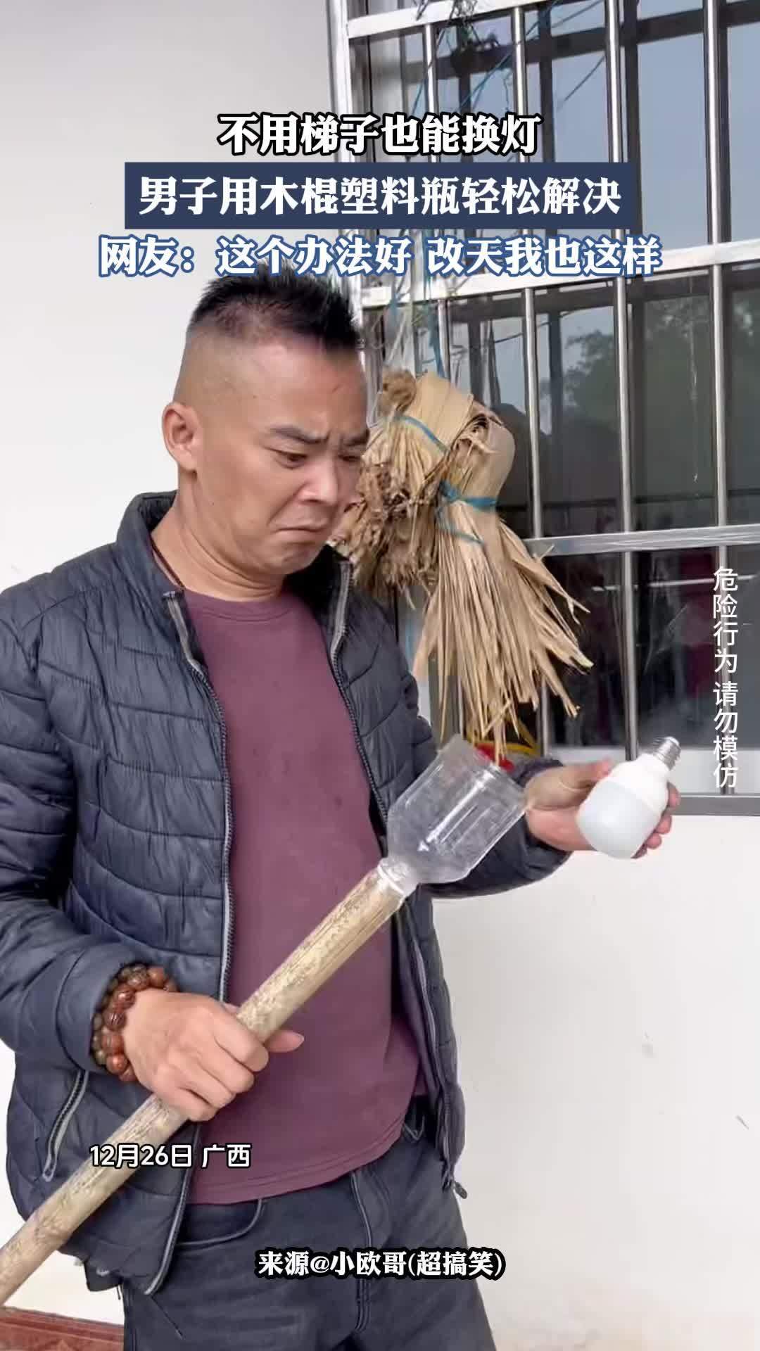 不用梯子也能换灯,男子用木棍塑料瓶轻松解决。
